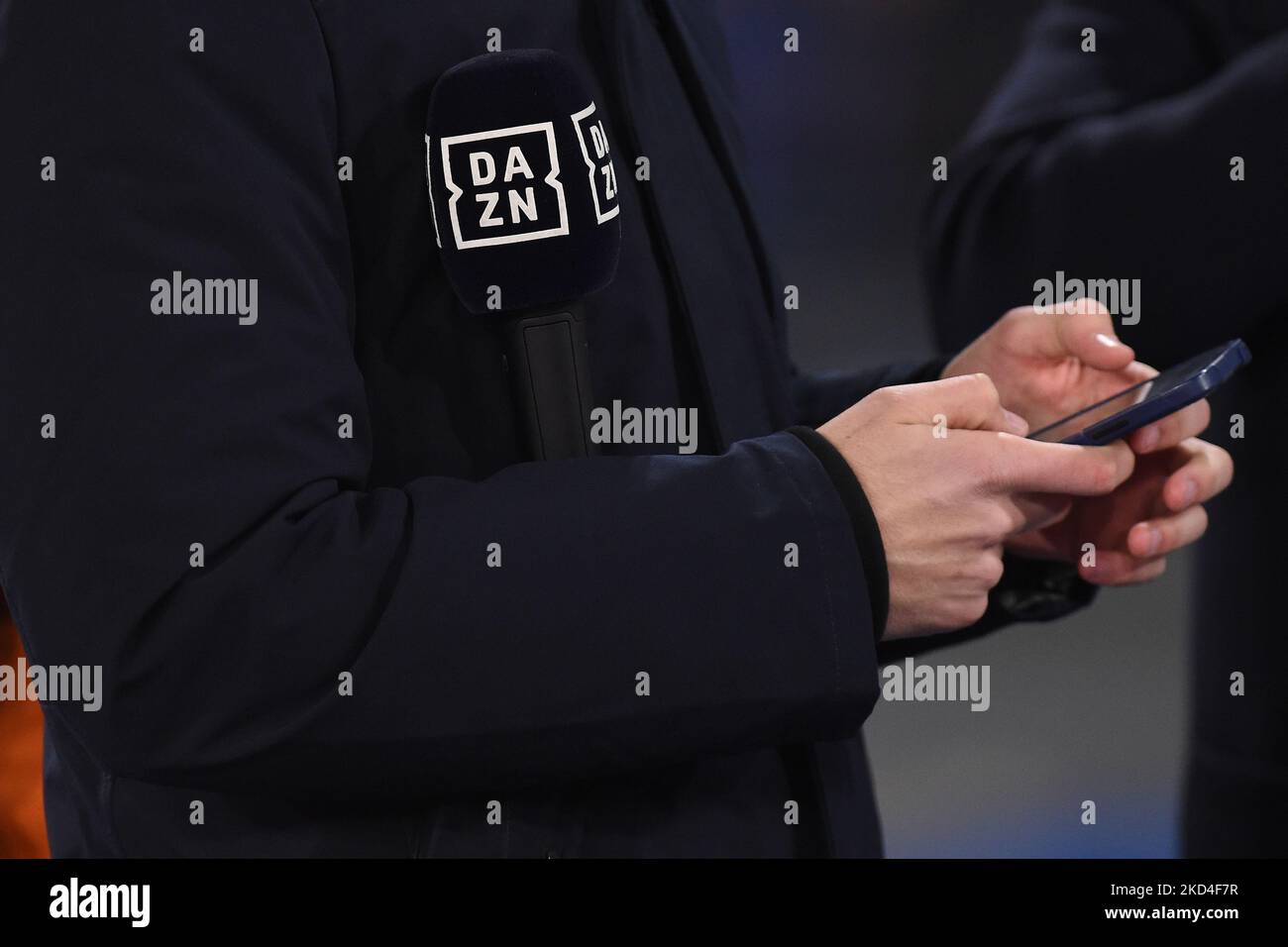 DAZN branded microphone is held by a pitchside commentator prior to ...