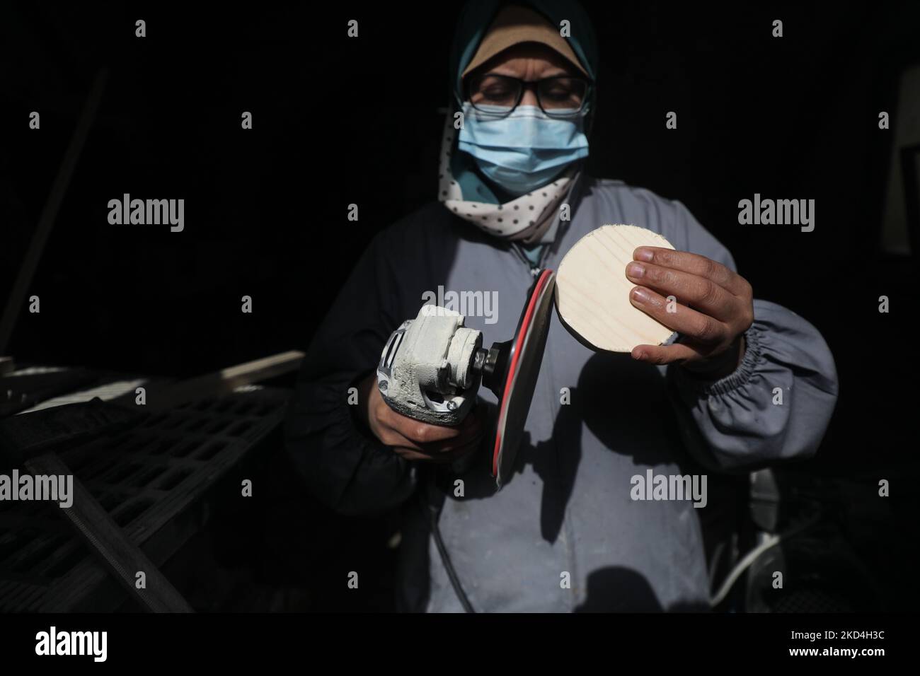 A Palestinian artisan works on toys in the workshop of Zeina ...
