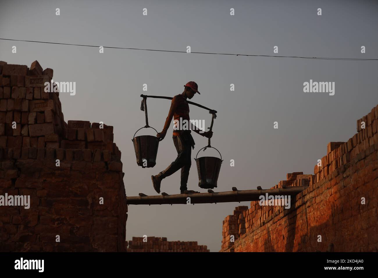 A Seasonal Migrant worker during work at a brick-making field at ...