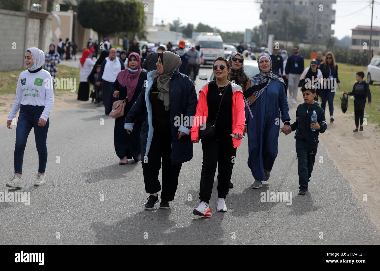 Palestinian women walk together marking International Women's Day, in ...