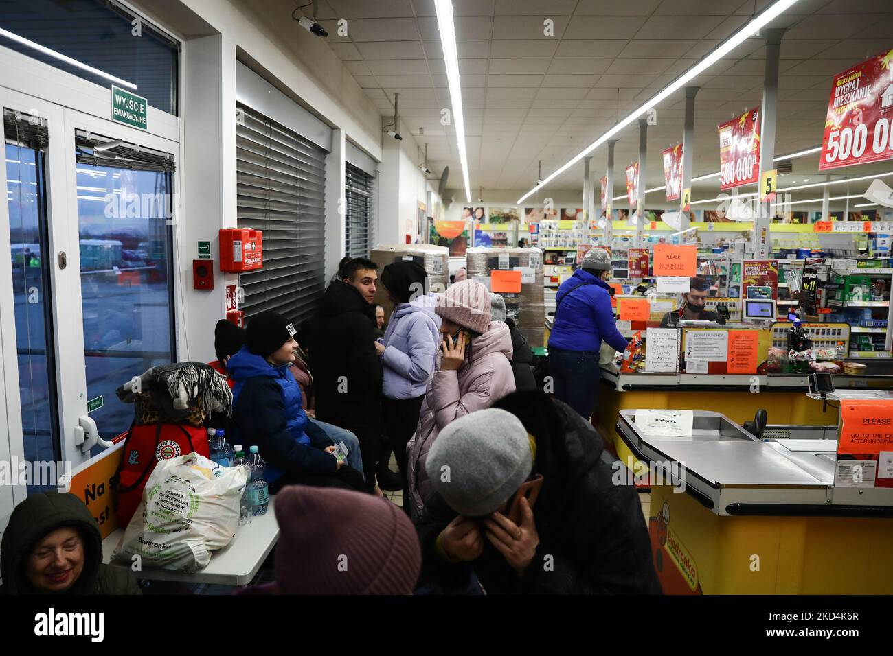 People fleeing from Ukraine rest inside the supermarket near the border ...