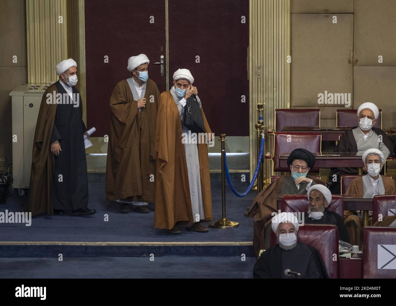 An Iranian cleric wears a protective face mask while attending Iran’s ...