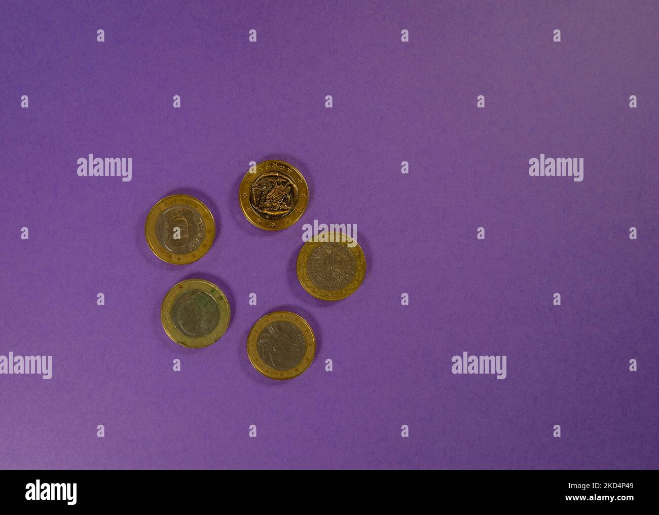five one Euro coins heads down isolated on a purple background Stock ...