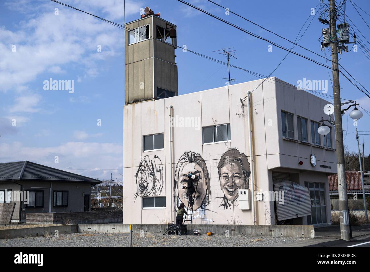 A man is drawing on the walls of the destroyed and abandoned fire ...