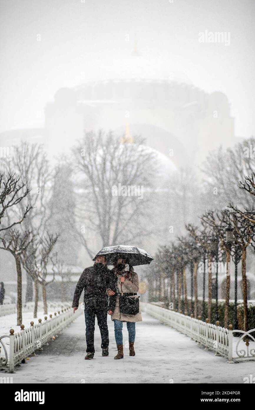 People walk during a snowfall in Istanbul, Turkey, on March 10, 2022 ...