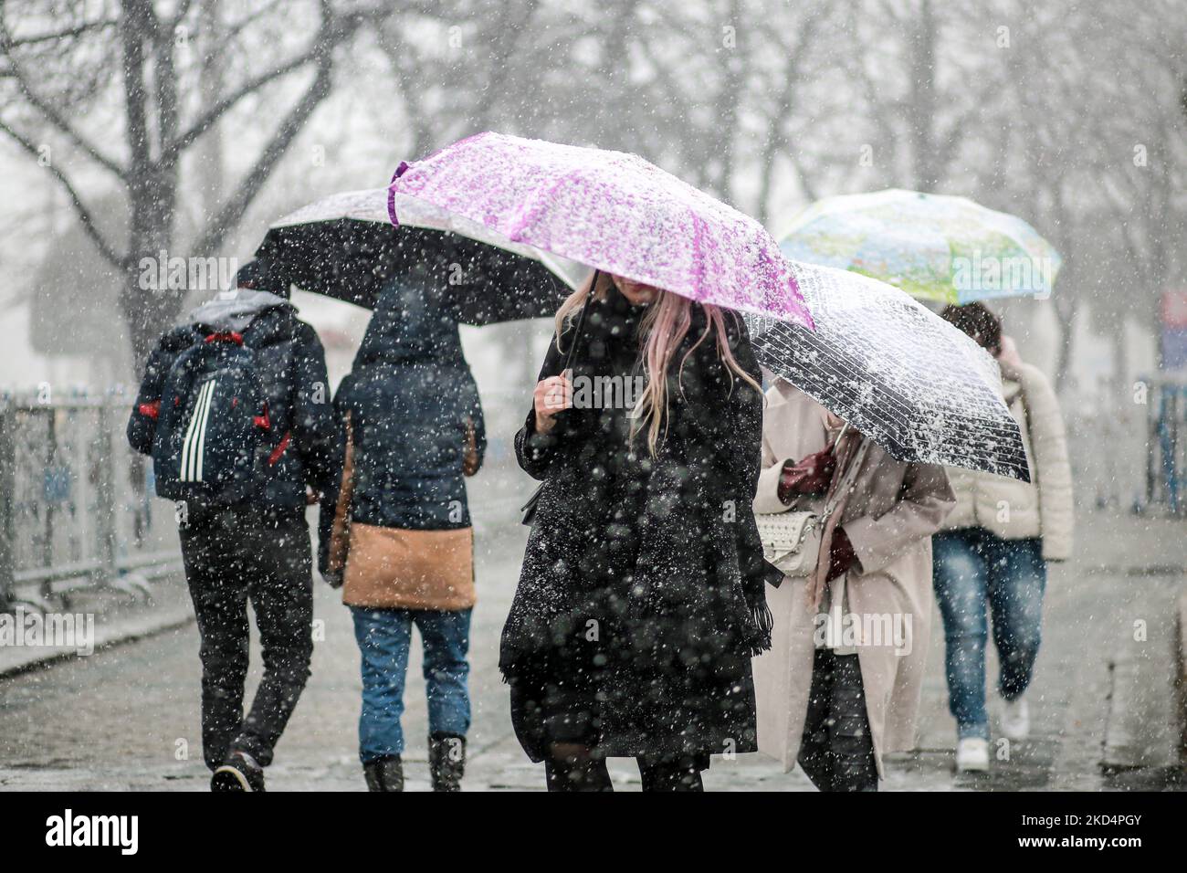 People walk during a snowfall in Istanbul, Turkey, on March 10, 2022 ...