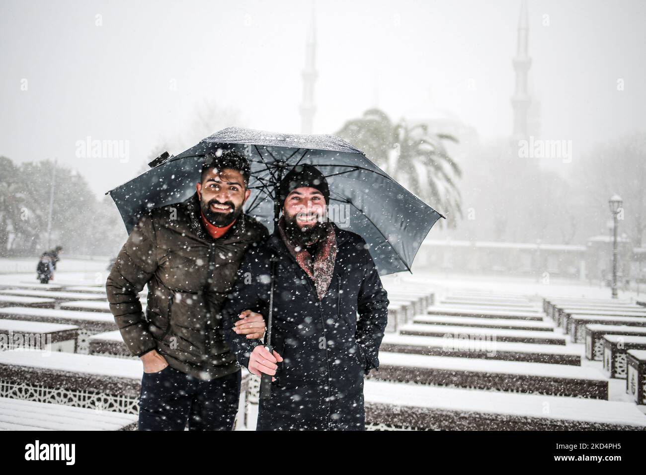 People walk during a snowfall in Istanbul, Turkey, on March 10, 2022 ...