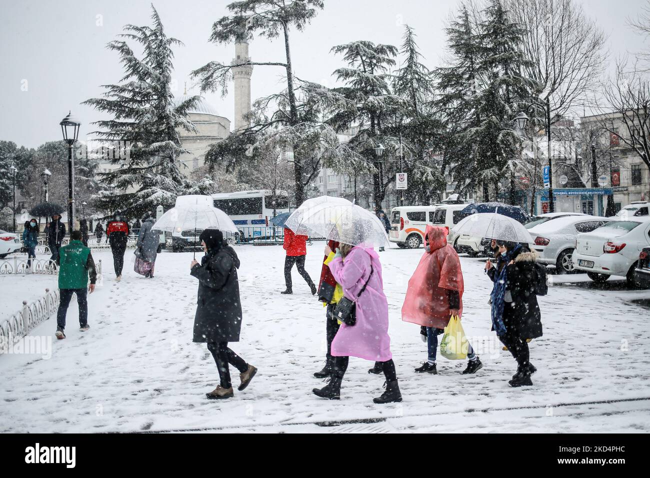 People walk during a snowfall in Istanbul, Turkey, on March 10, 2022 ...