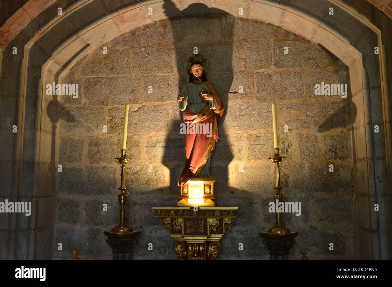 The statue of Jesus Christ in a church illuminated by a light Stock ...