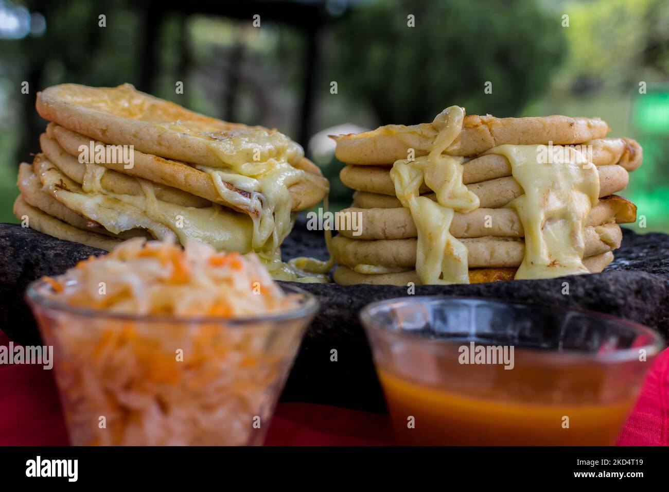 typical Salvadoran dish, cheese pupusas with cabbage and tomato sauce ...
