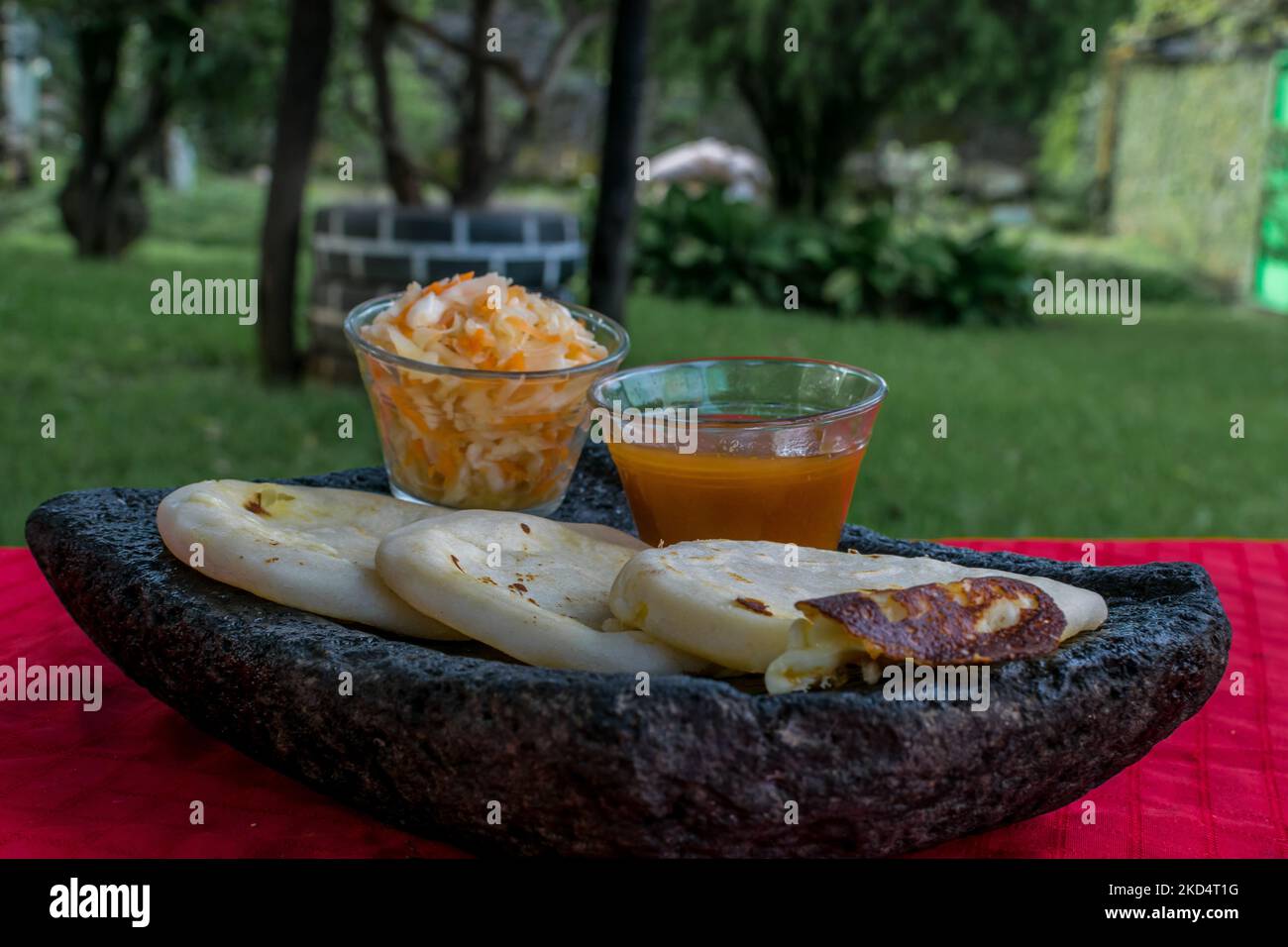typical Salvadoran dish, cheese pupusas with cabbage and tomato sauce ...