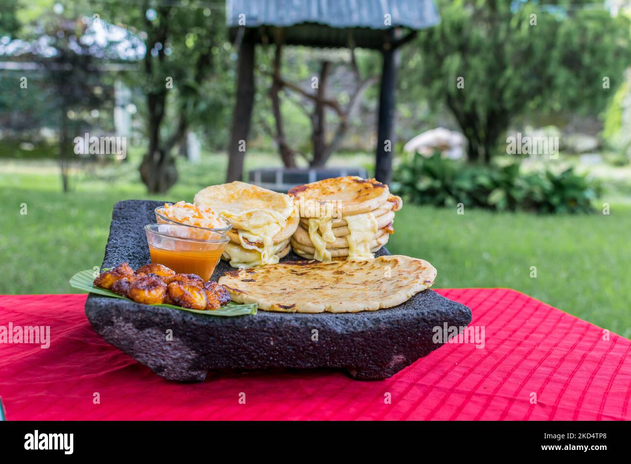 typical Salvadoran dish, cheese pupusas with cabbage and tomato sauce ...