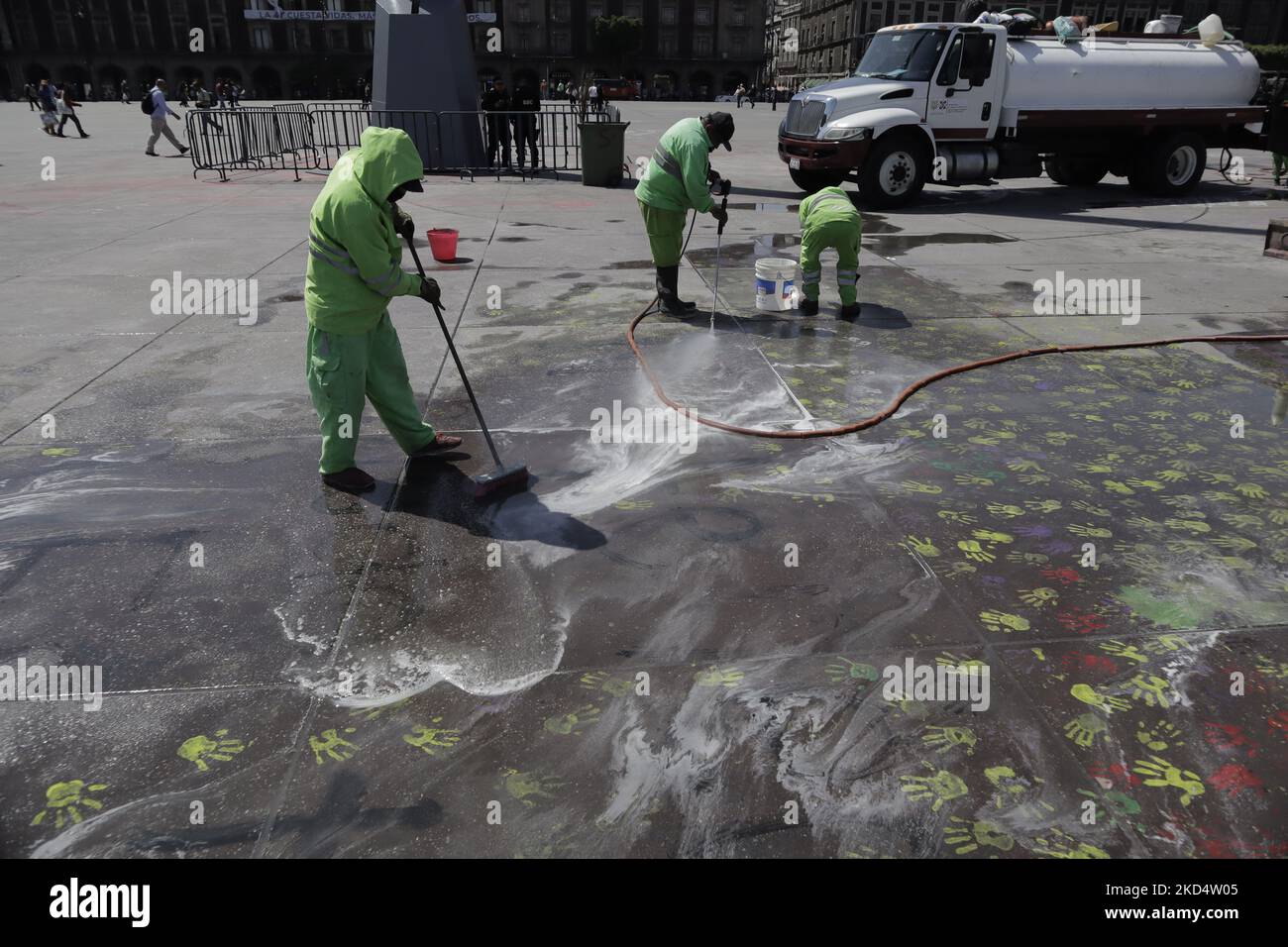 Cleaning workers erase graffiti painted by feminist groups on ...