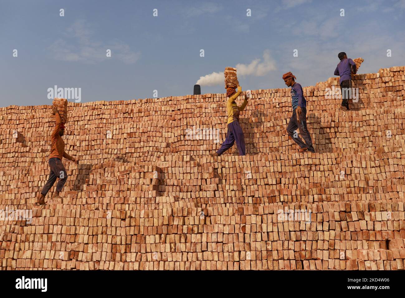 Workers are working at a brickyard in Dhaka, Bangladesh. (Photo by Kazi ...