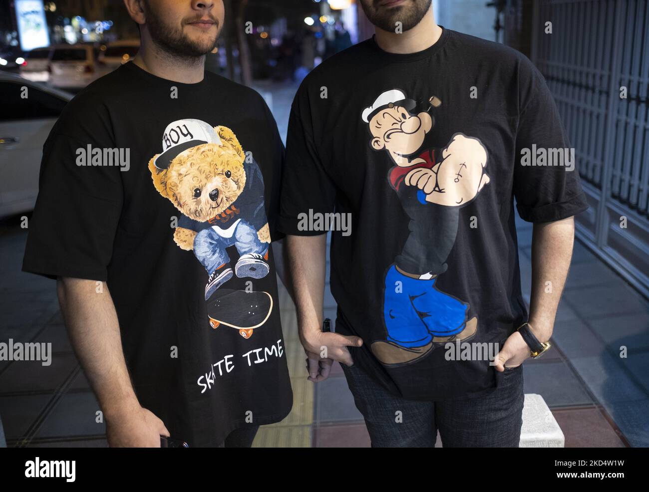 Two Iranian men pose for a photograph on a street-side in the holy city ...