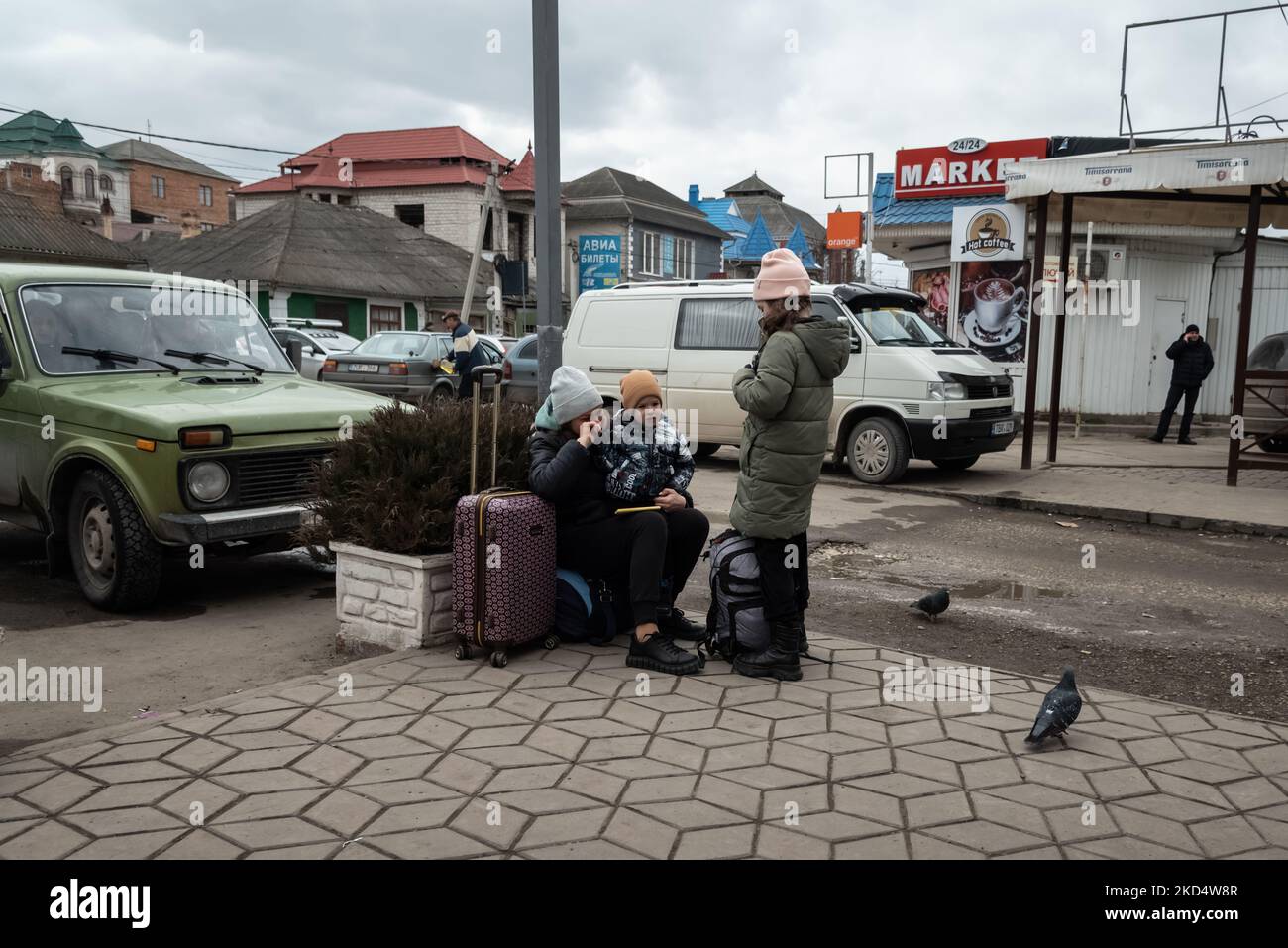 An Ukrainian family of three is seen resting just having cross the ...