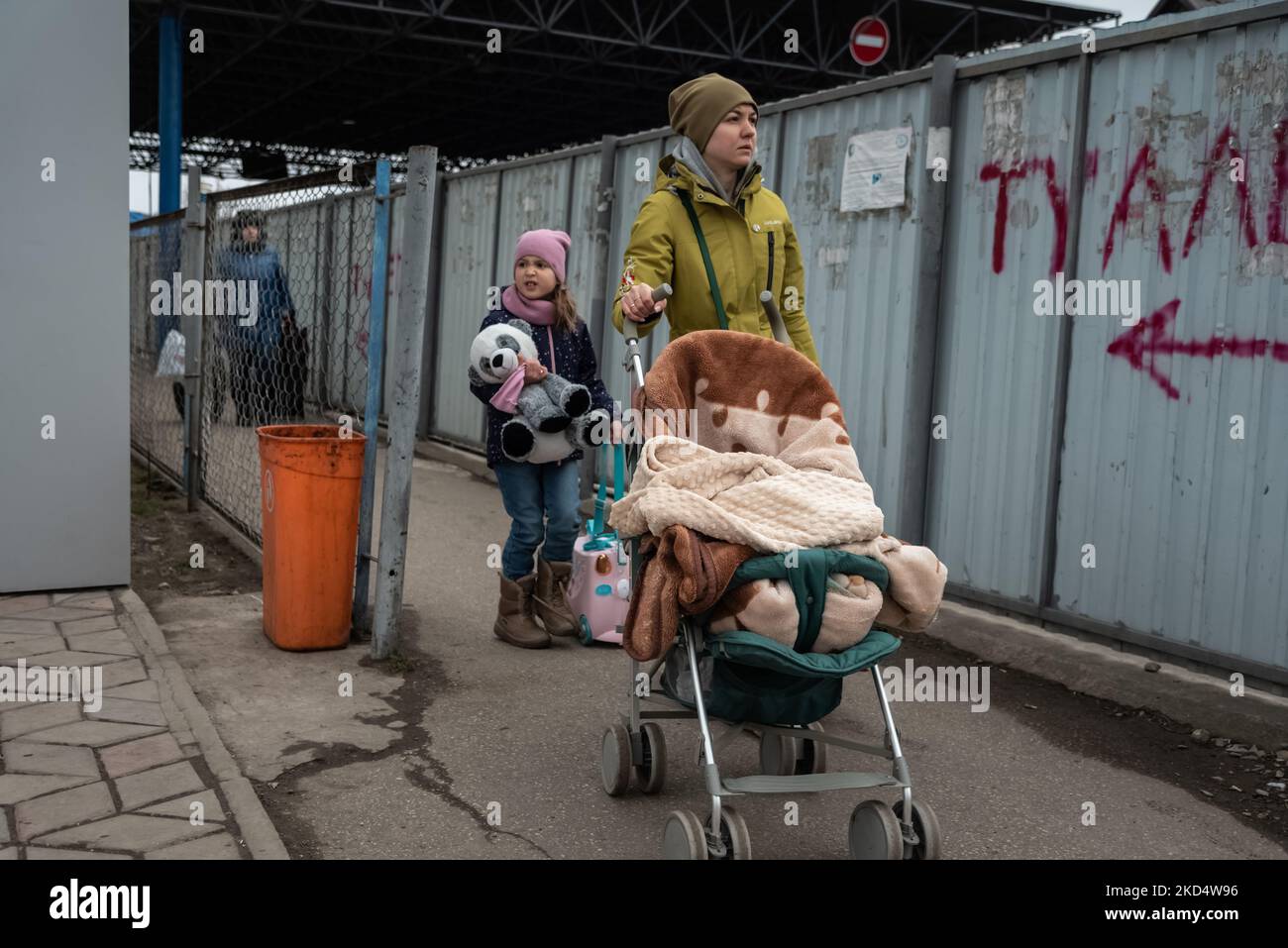 An Ukrainian mother and her daughter are seen just having cross the ...