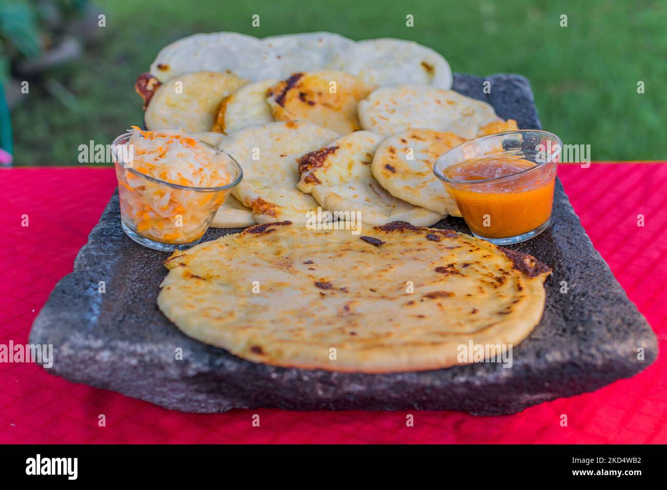 typical Salvadoran dish, cheese pupusas with cabbage and tomato sauce ...