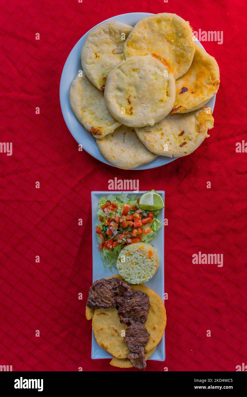 typical Salvadoran dish, cheese pupusas with cabbage and tomato sauce ...