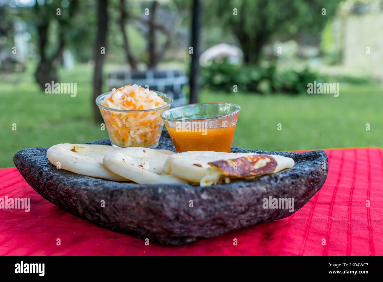 typical Salvadoran dish, cheese pupusas with cabbage and tomato sauce ...