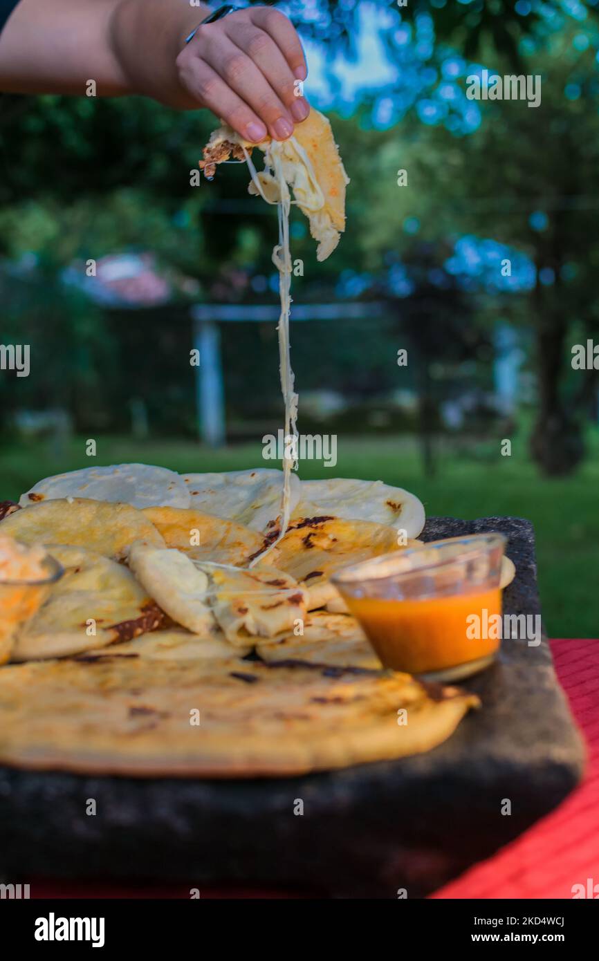 typical Salvadoran dish, cheese pupusas with cabbage and tomato sauce ...