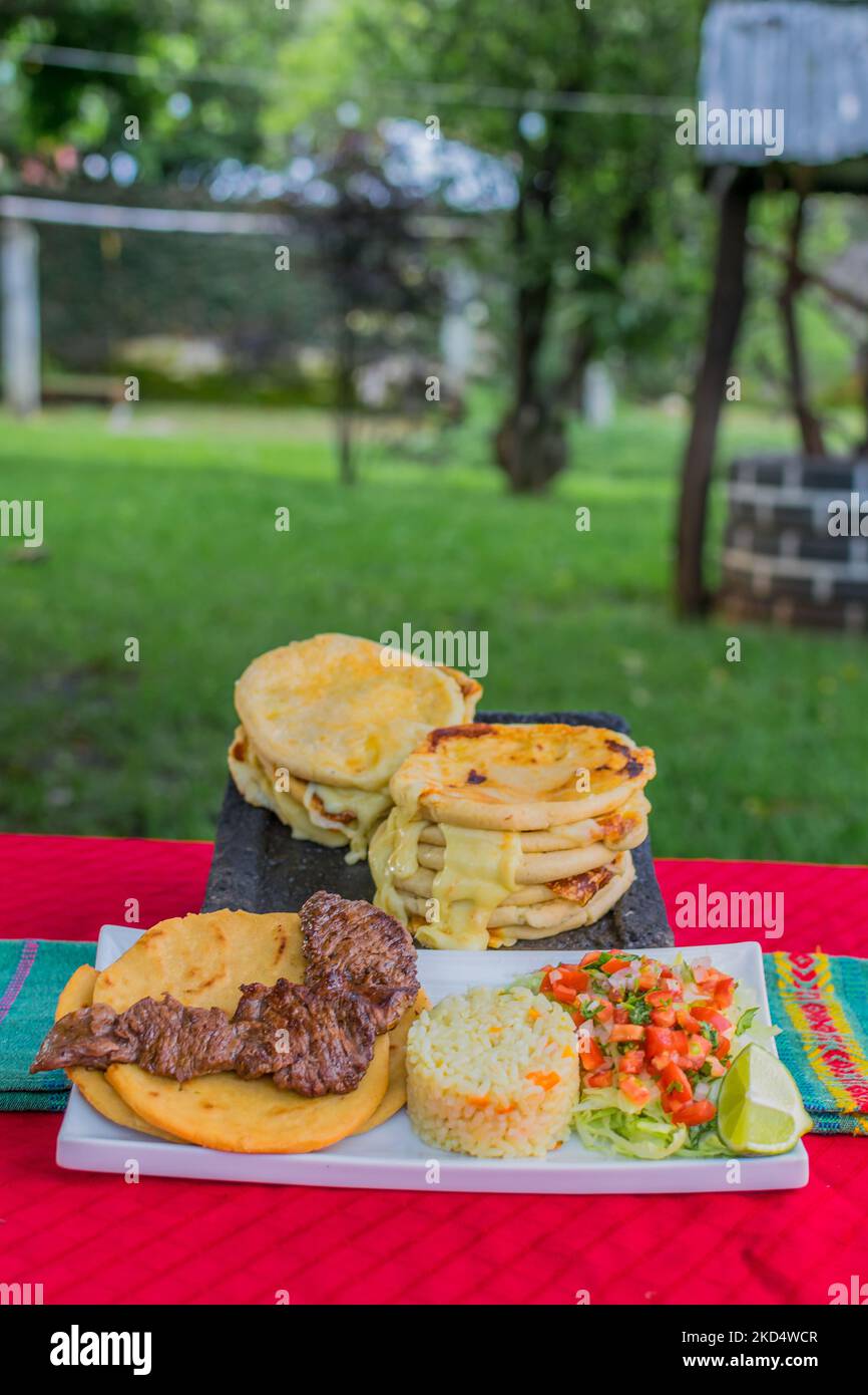 typical Salvadoran dish, cheese pupusas with cabbage and tomato sauce ...