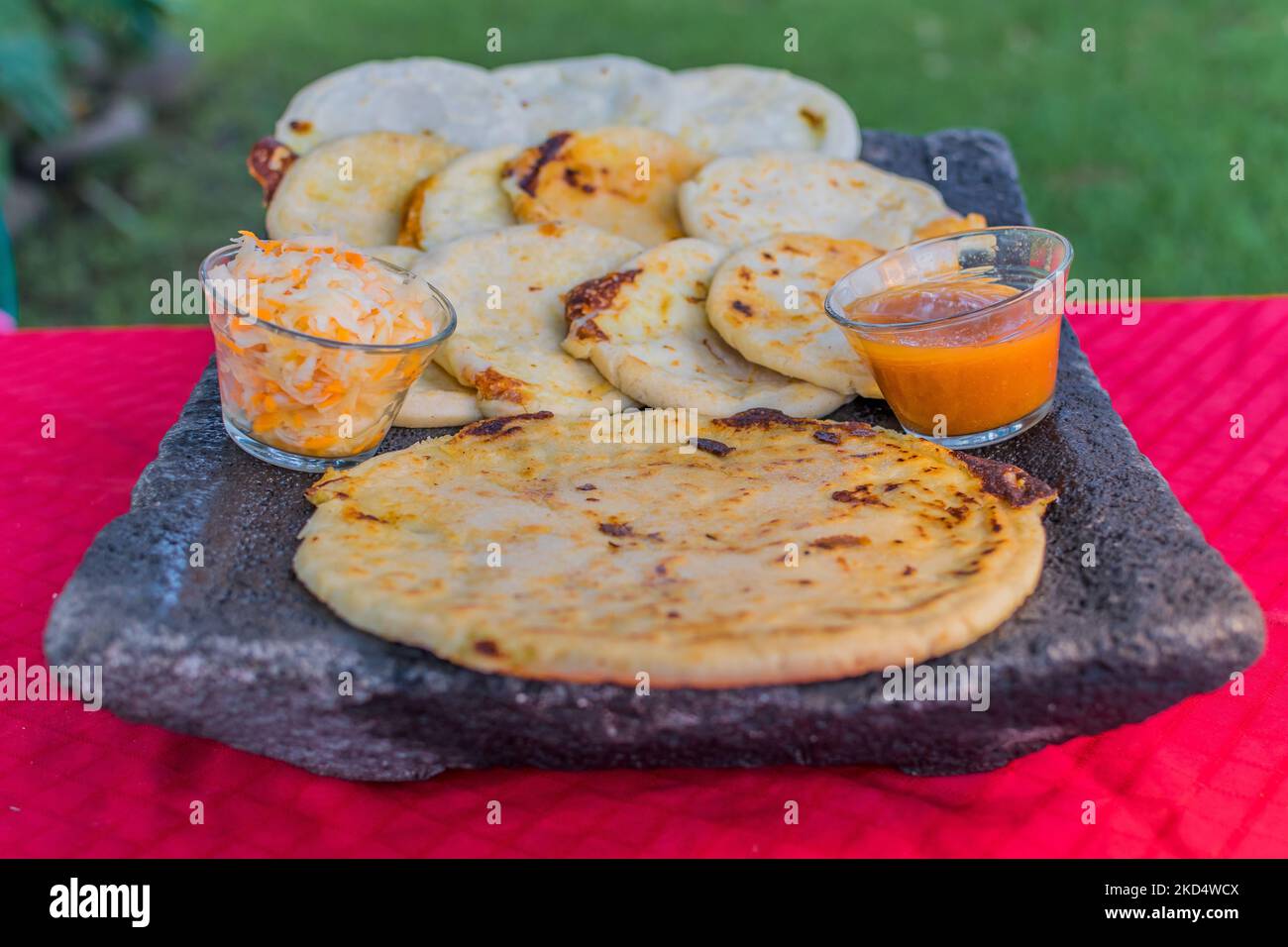 typical Salvadoran dish, cheese pupusas with cabbage and tomato sauce ...