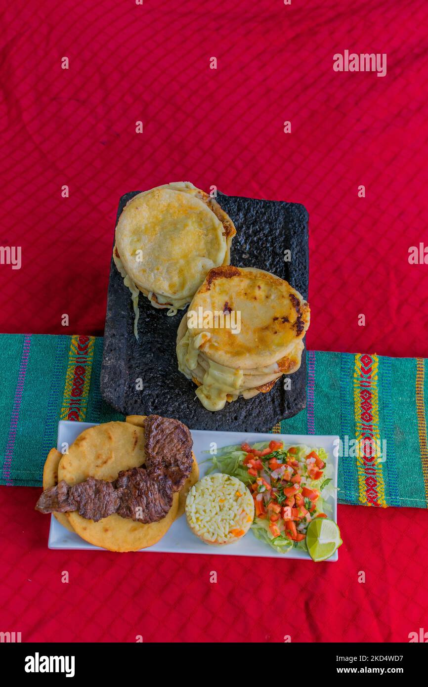 typical Salvadoran dish, cheese pupusas with cabbage and tomato sauce ...