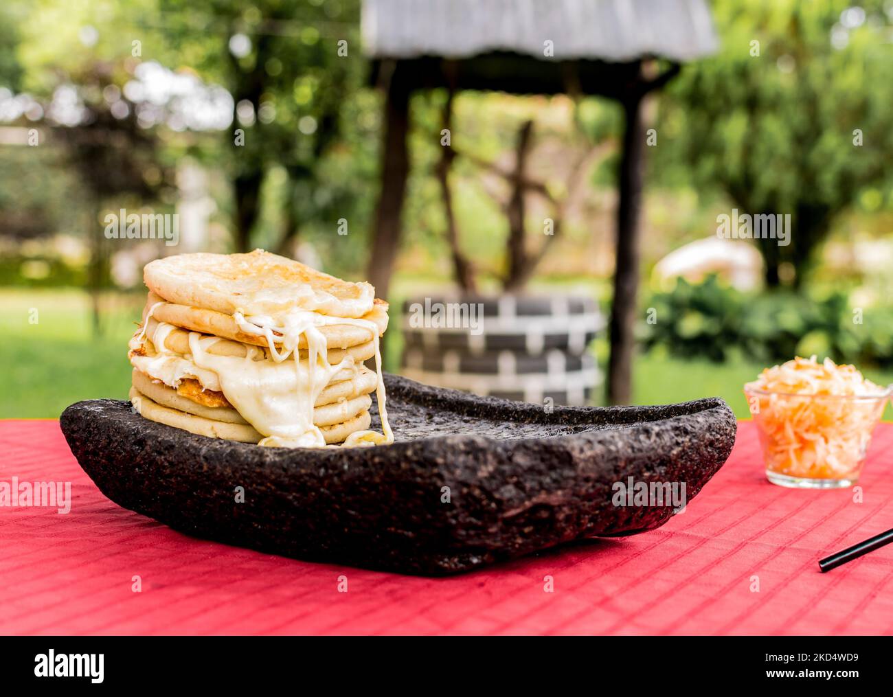 typical Salvadoran dish, cheese pupusas with cabbage and tomato sauce ...