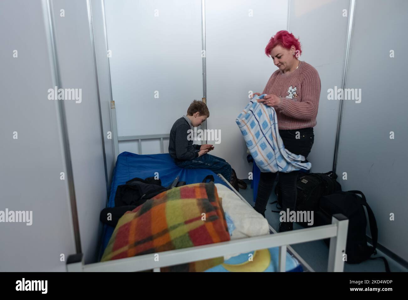An Ukrainian mother and son are seen inside their room at the MoldEXPO ...