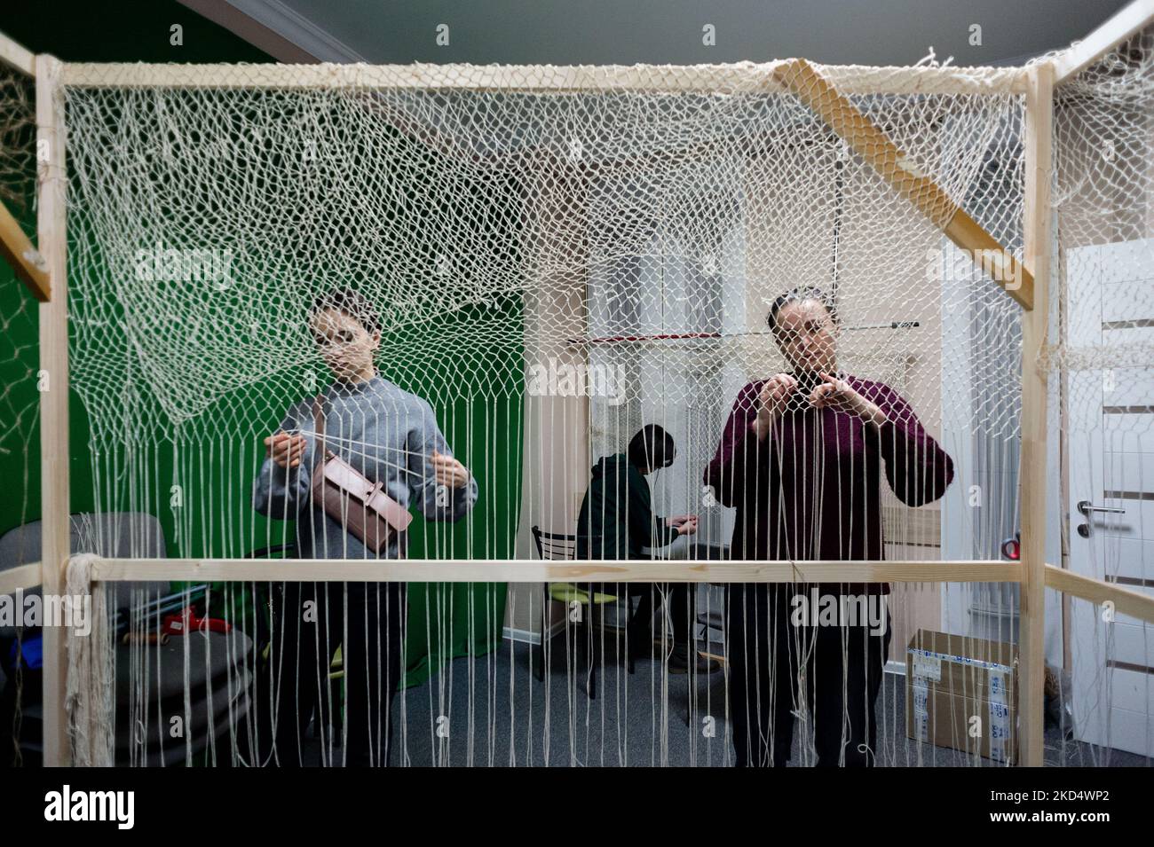 Members of the non profit organisation, New Acropolis weave netting for ...