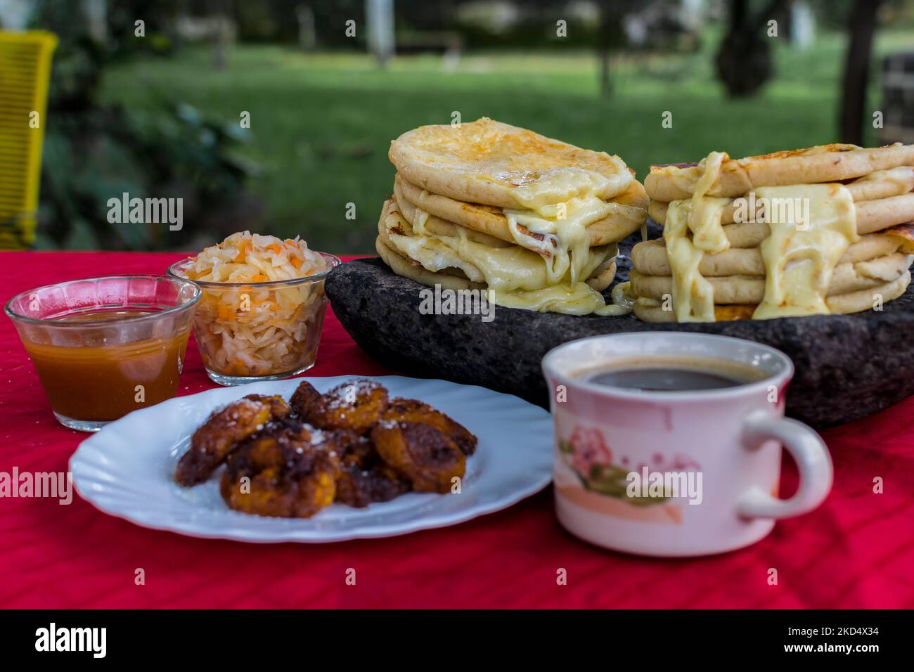 typical Salvadoran dish, cheese pupusas with cabbage and tomato sauce ...