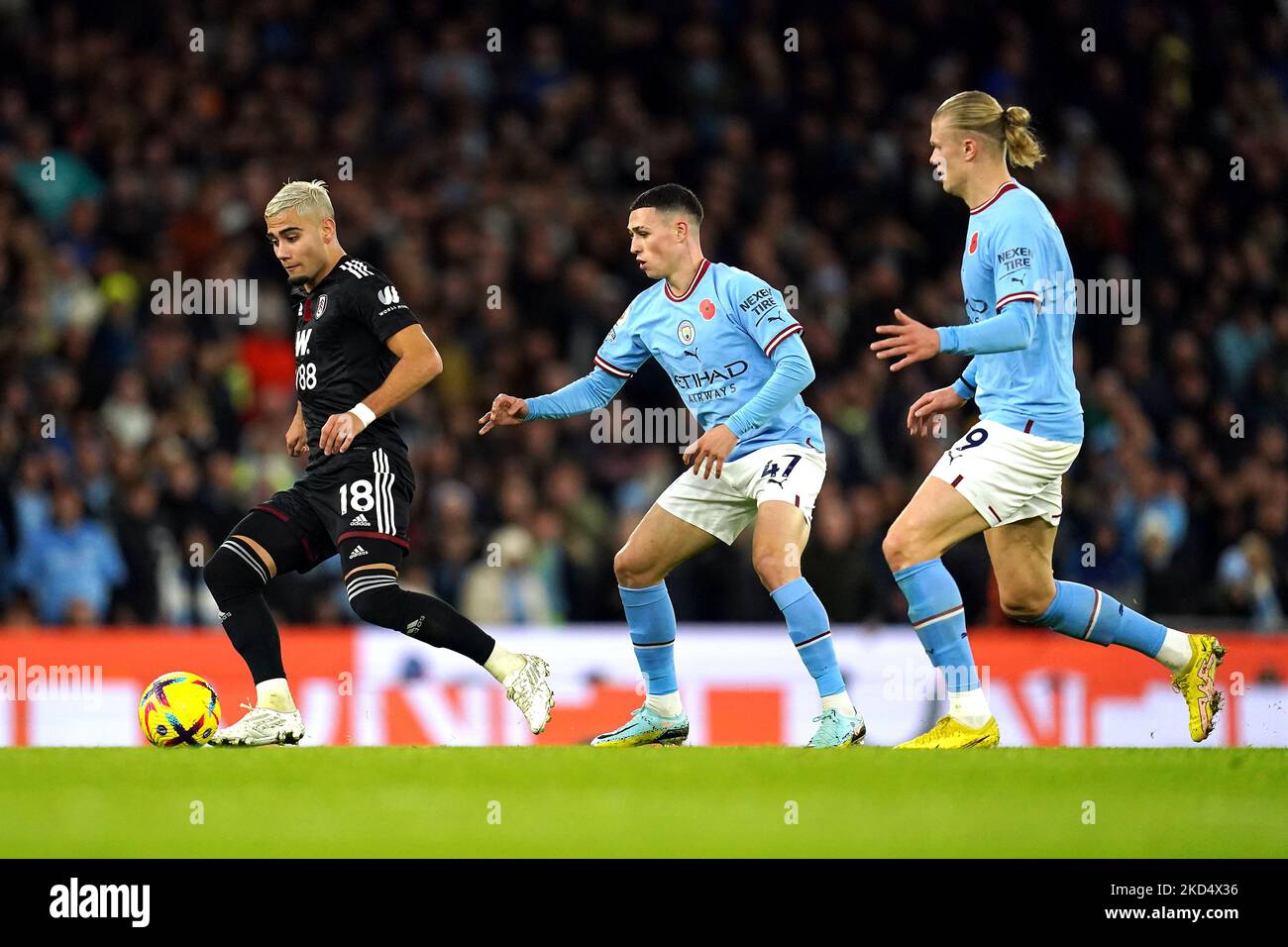 Fulham's Andreas Pereira (left) battles for the ball with Manchester ...