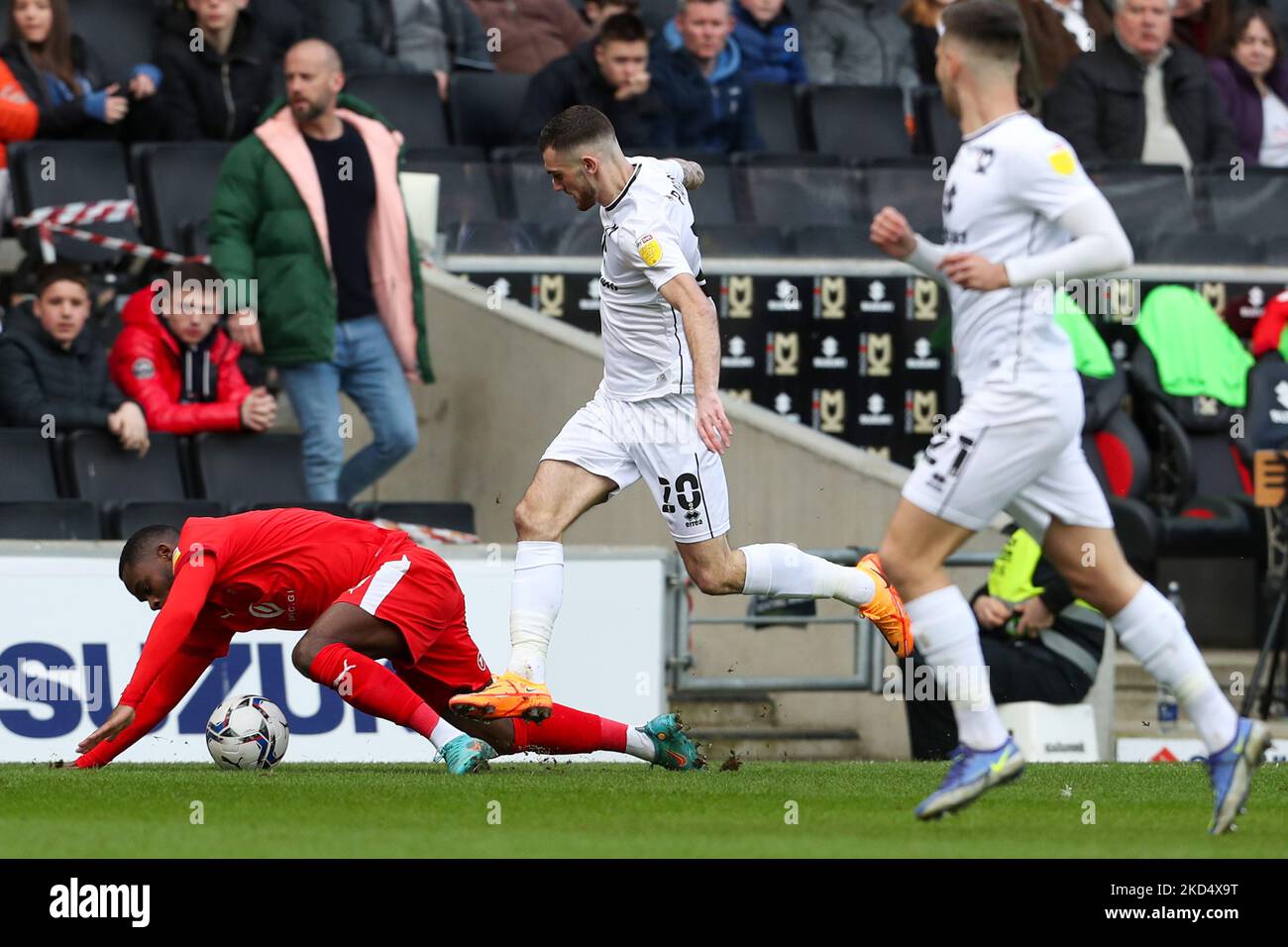 Wigan Athletic's Gavin Massey is challenged by Milton Keynes Dons Troy ...