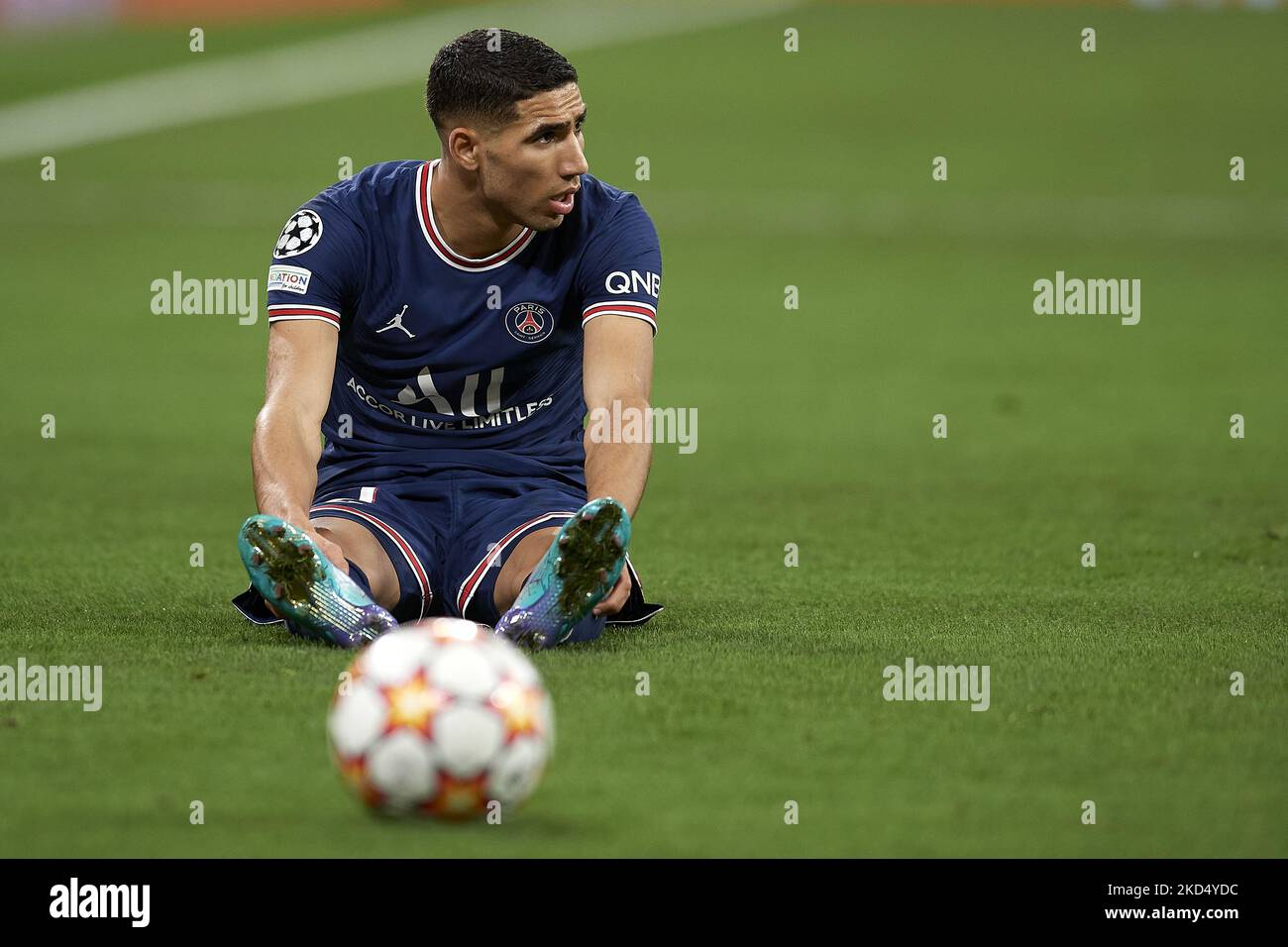 Achraf Hakimi of PSG lies injured on the pitch during the UEFA ...