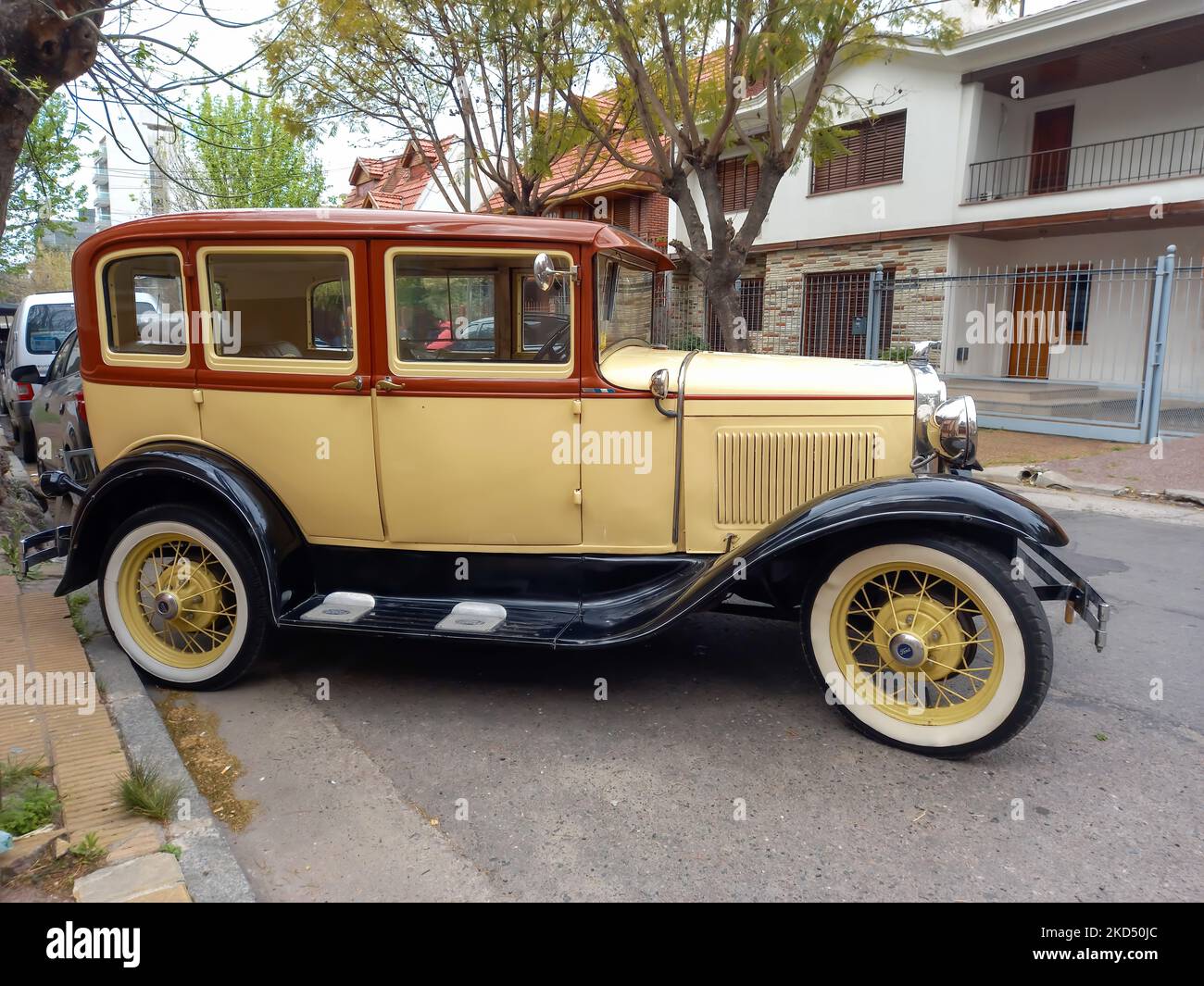 Old cream 1930s Ford Model A Fordor sedan three window hardtop parked ...