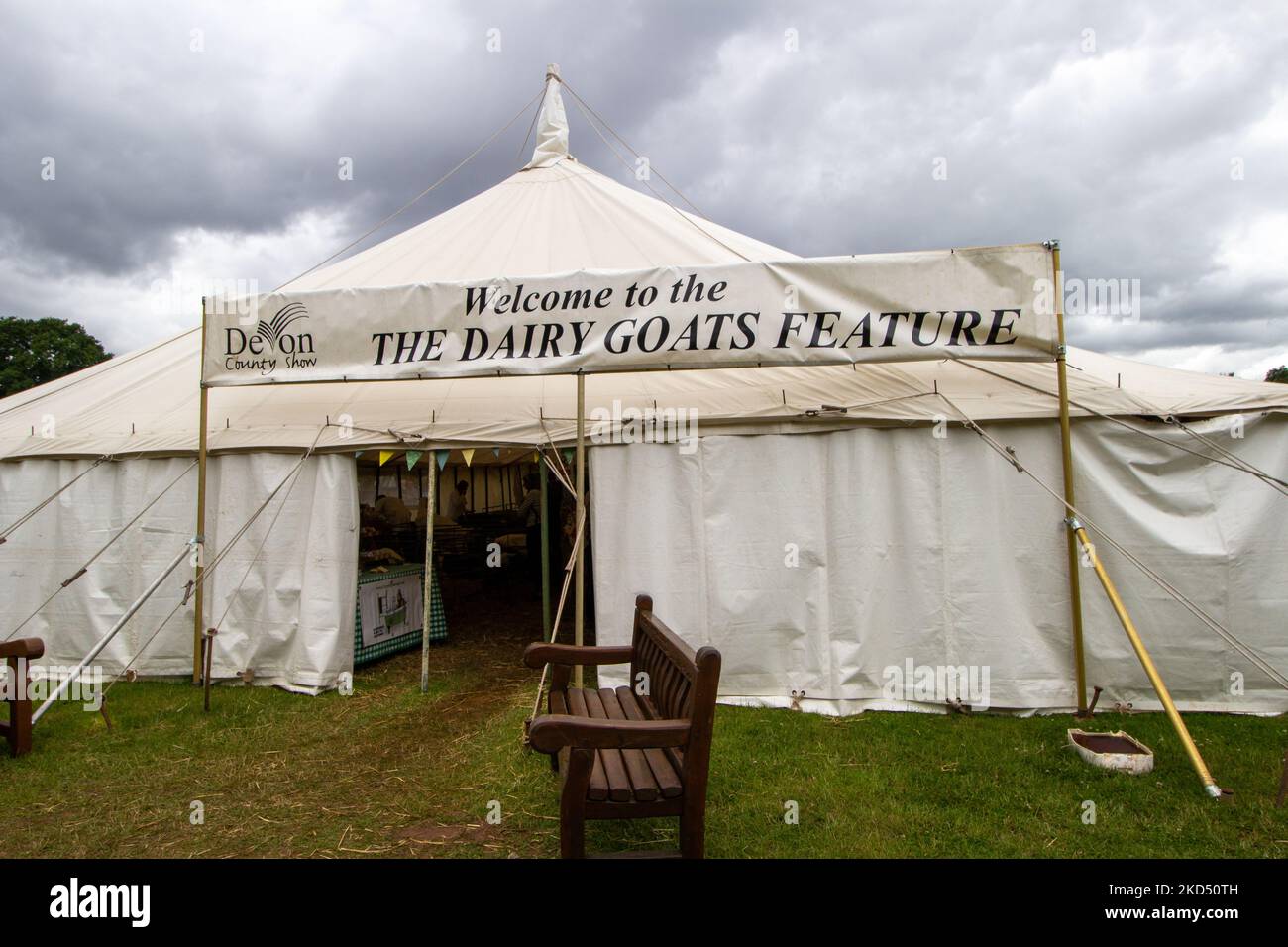 EXETER, DEVON, UK - JULY 1, 2022 Dairy Goat tent with dark storm clouds ...