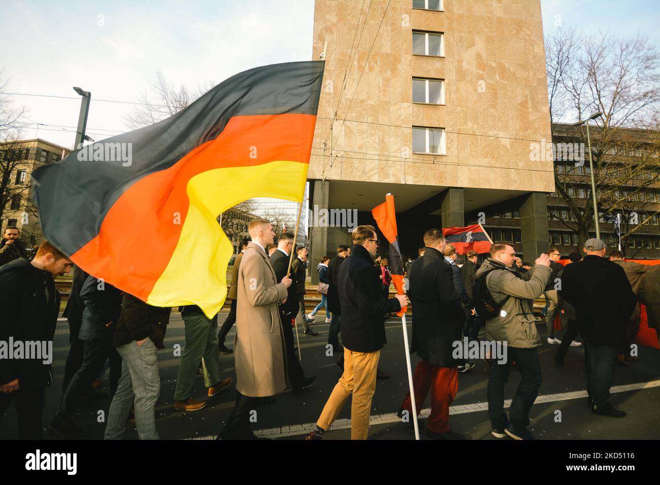 protesters hold the german flag is seen during the weekly anti ...