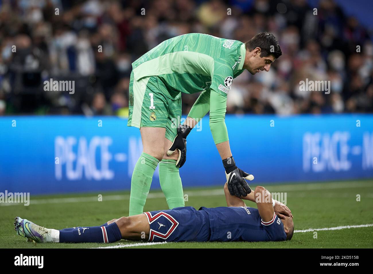 Thibaut Courtois of Real Madrid comforts Kylian Mbappe of PSG during ...
