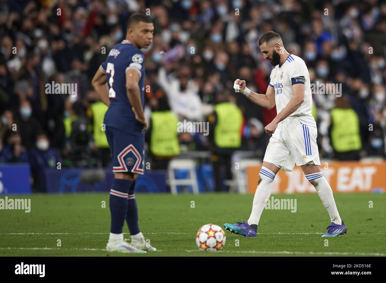 Karim Benzema of Real Madrid celebrates front Kylian Mbappe of PSG ...