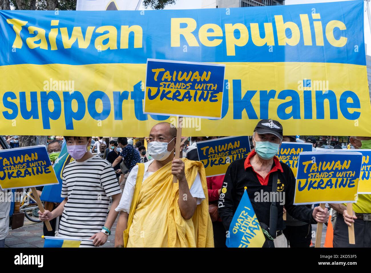 Group of People standing in front of a big banner reading the Taiwan ...