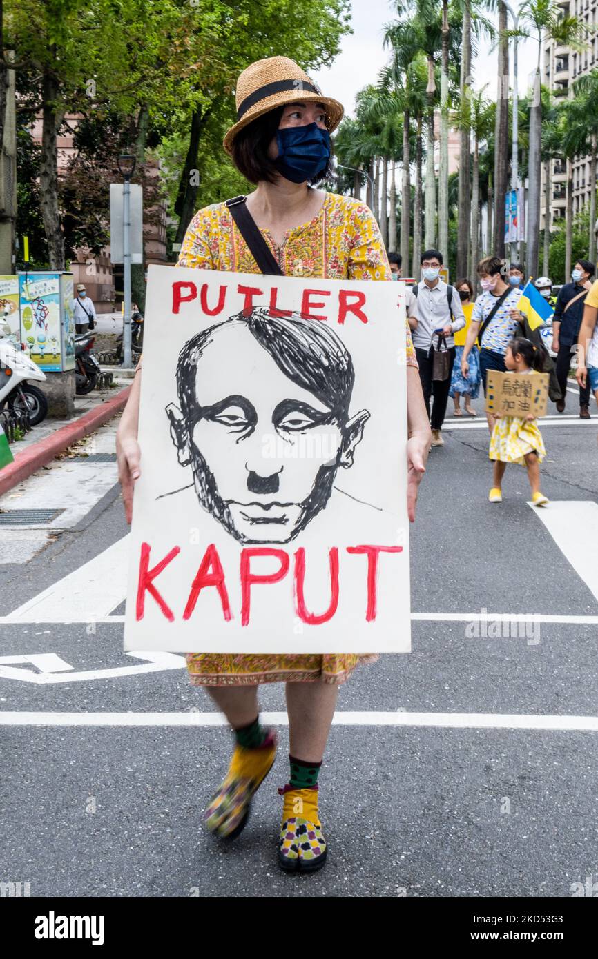 Woman holin wig sign with Putin's face reading Putler Kaput. Taipei ...