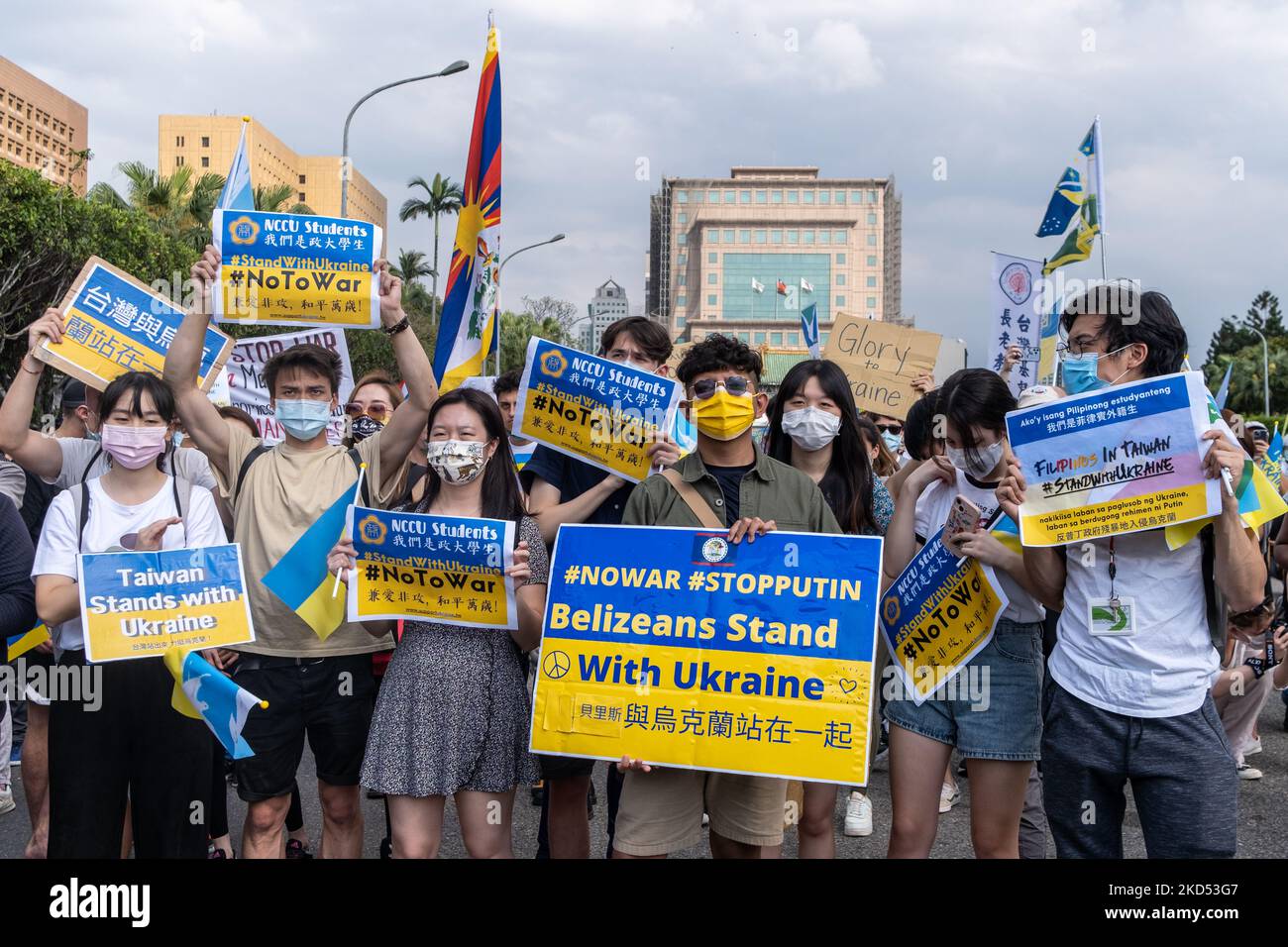 Group of people holding signs with the Colors of Ukraine saying “Taiwan ...