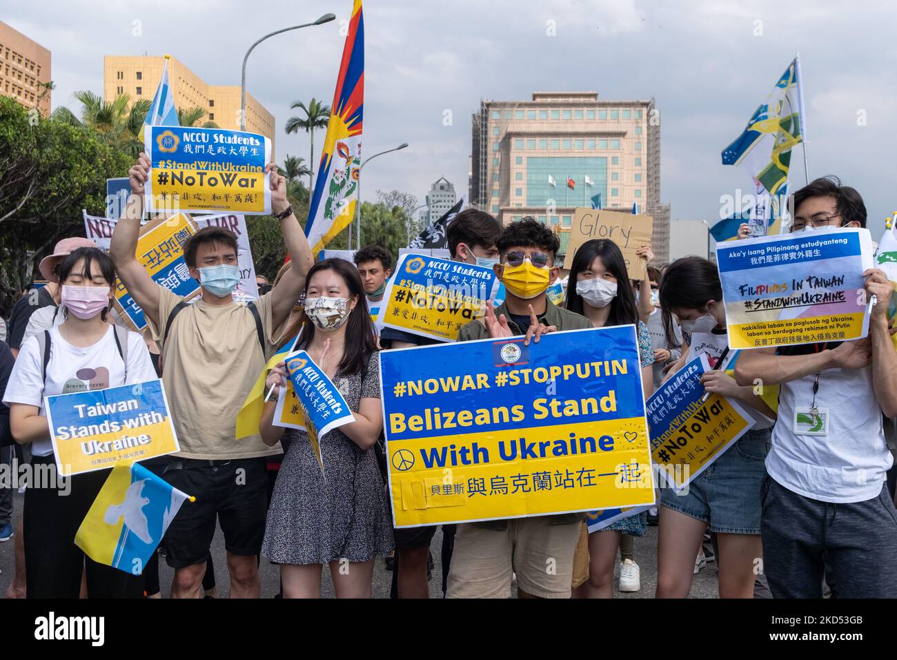 Group of people holding signs with the Colors of Ukraine saying “Taiwan ...