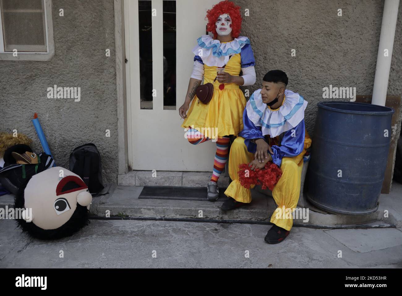 Two young men dressed as clowns get ready to participate in the ...