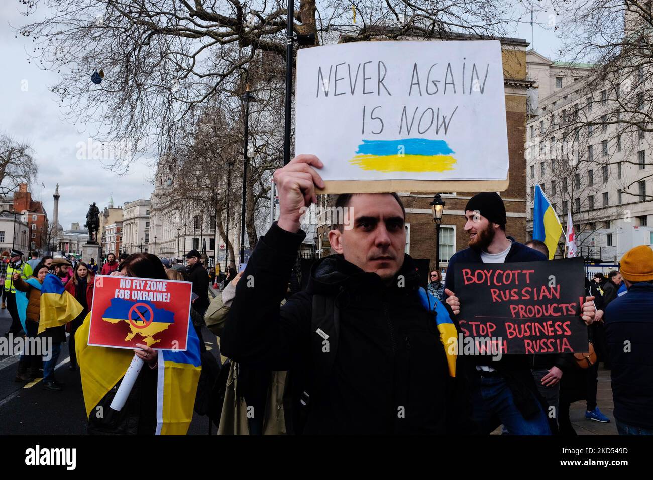 People hold placards supporting Ukraine outside Downing street in London (Photo by Jay Shaw ...