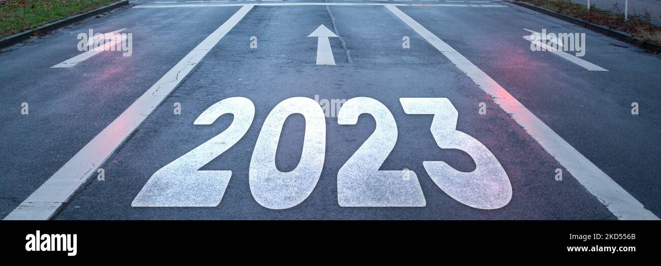 detail of an asphalt street with arrows on the lane and "2023" written ...