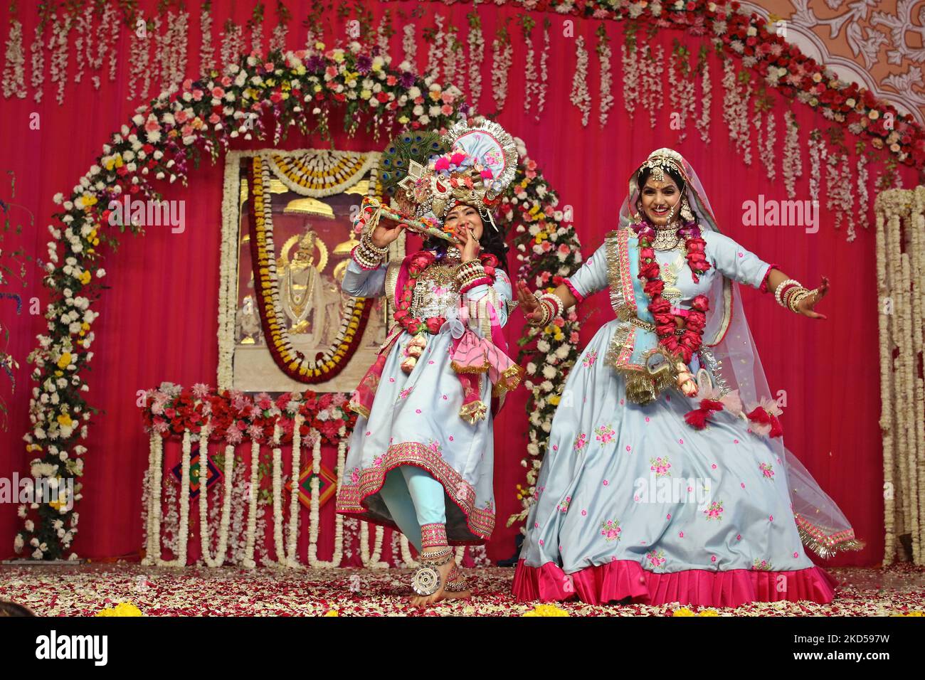 Artists dressed as Lord Krishna and Goddess Radha perform during the ...
