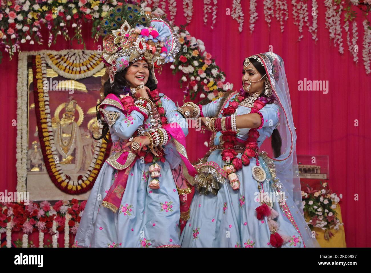 Artists dressed as Lord Krishna and Goddess Radha perform during the ...