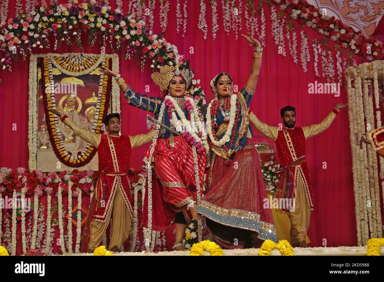 Artists dressed as Lord Krishna and Goddess Radha perform during the ...